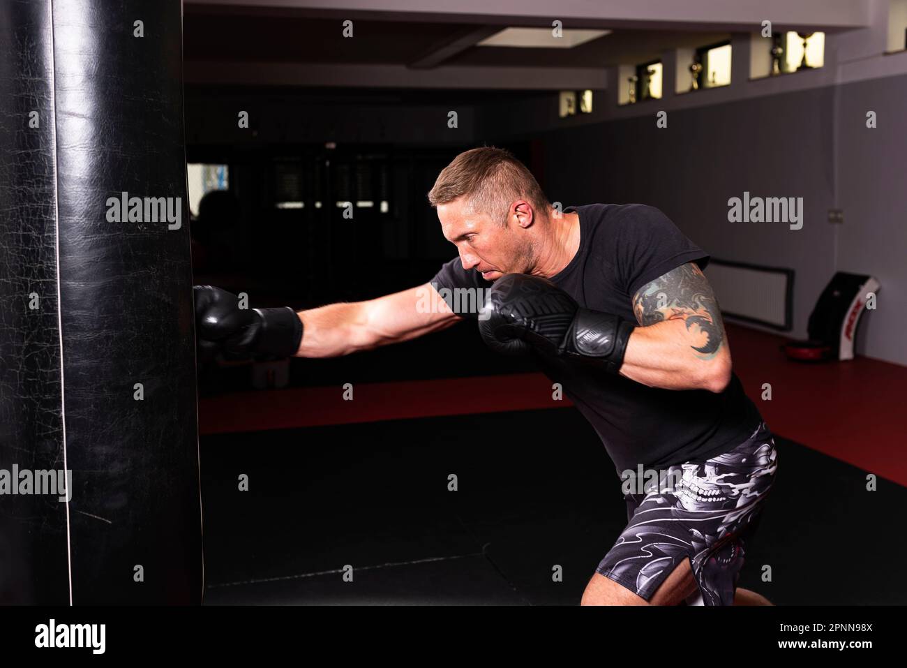 An athletic young adult man is performing a high-intensity workout ...