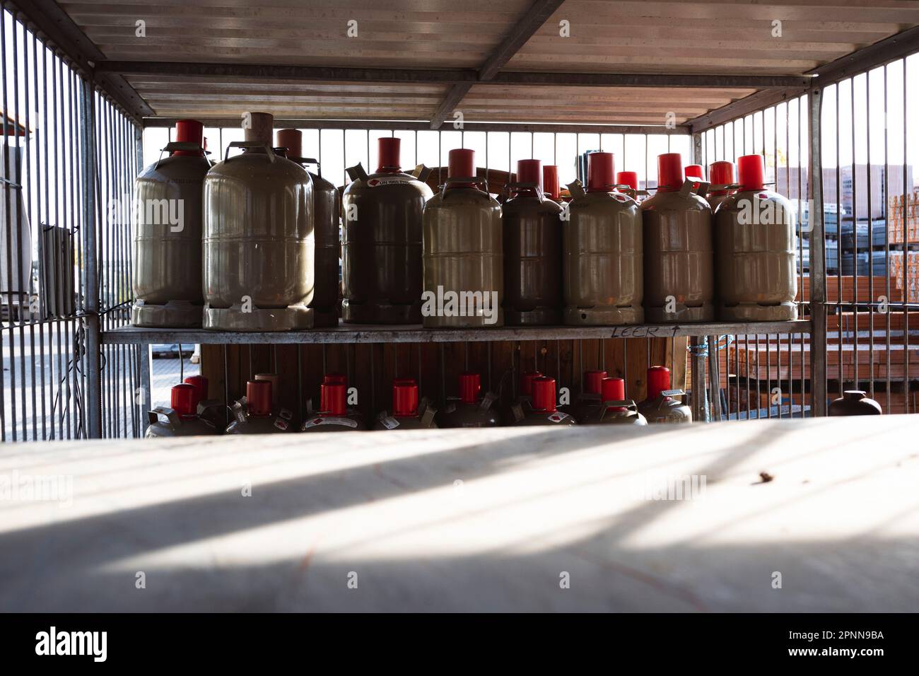 An array of empty stainless steel tanks are placed on a metallic ...