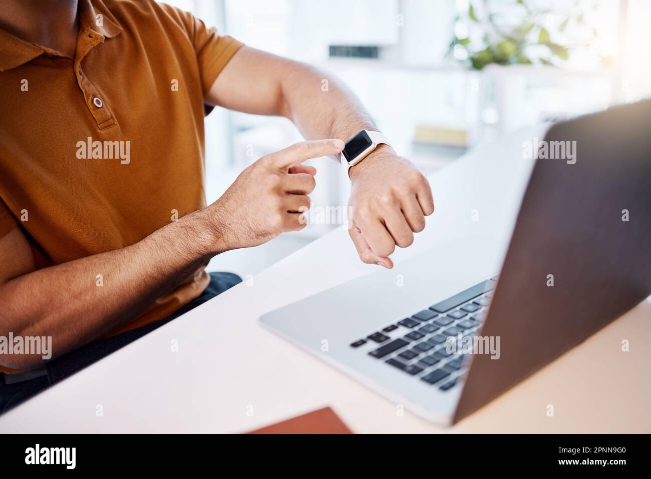 Man, hands and watch by laptop for time, schedule or monitoring heart ...