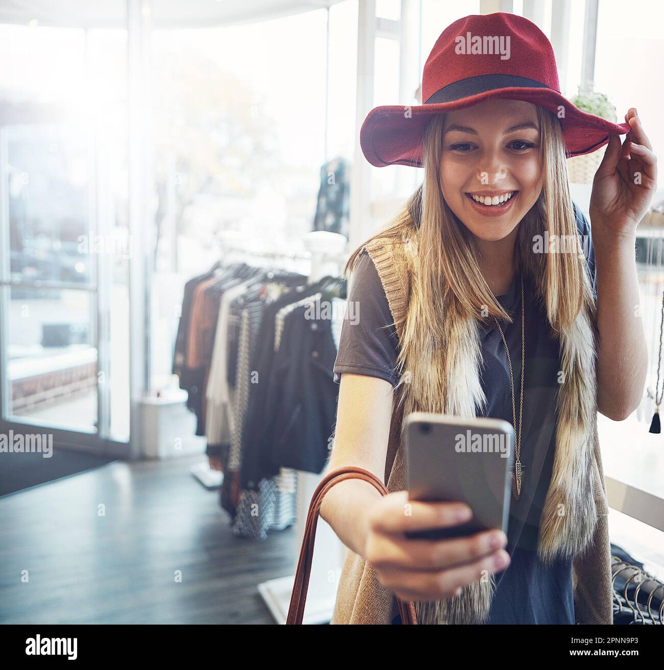 Snapping a selfie in her favourite store. an attractive young woman ...