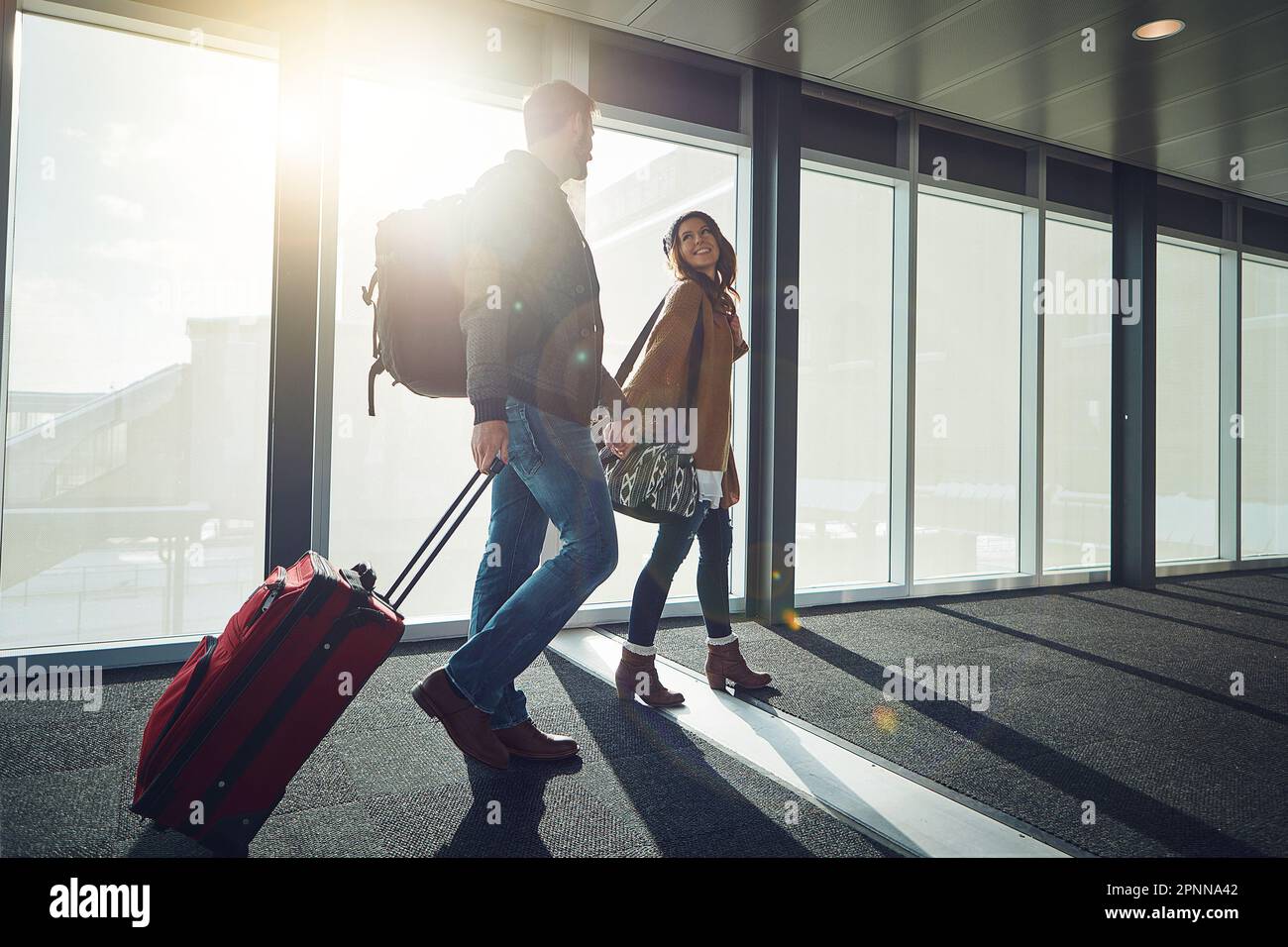 Im not letting go of your hand for one second. a young couple walking ...