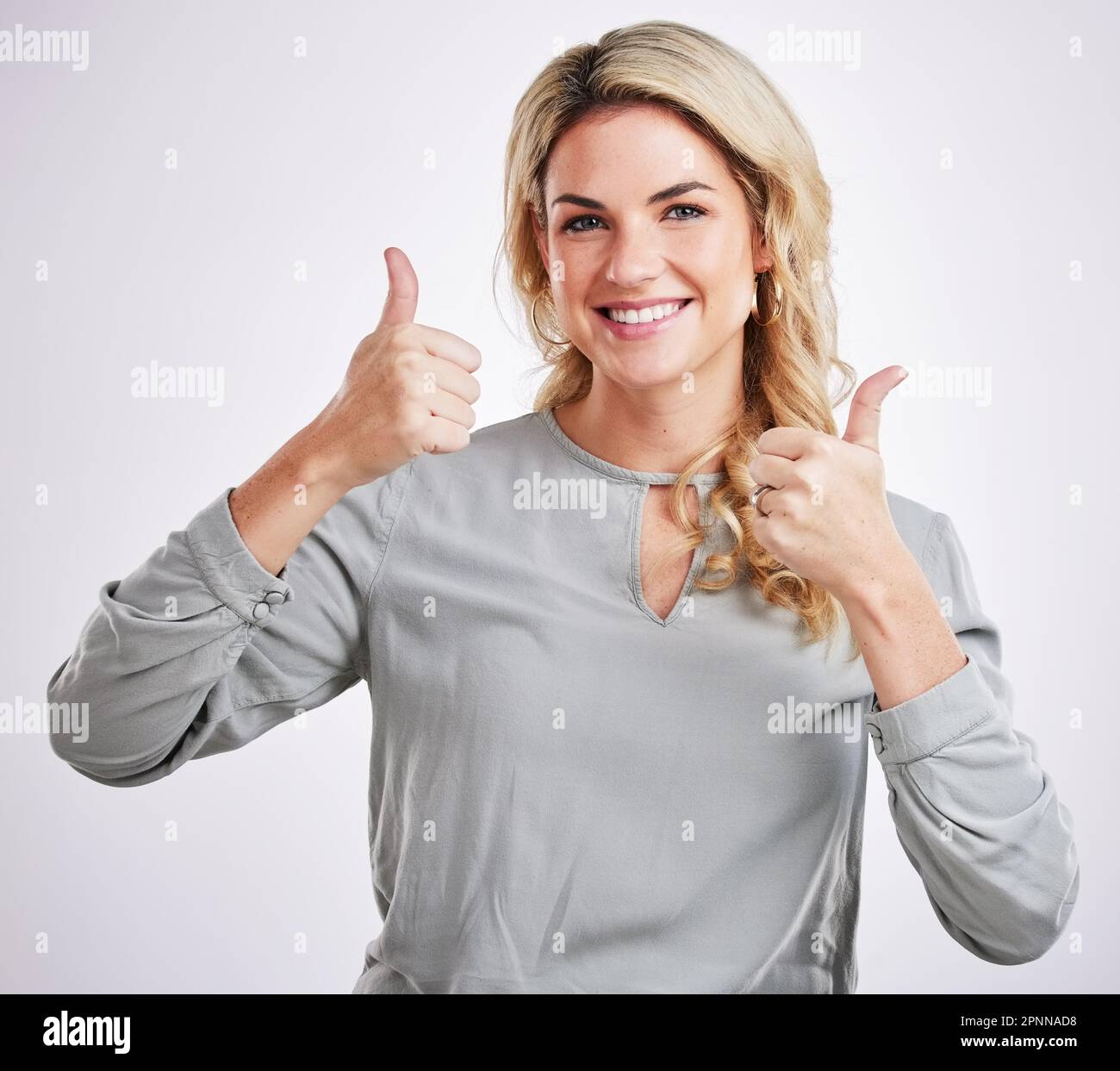 Portrait, thumbs up and motivation with a woman on a gray background in ...