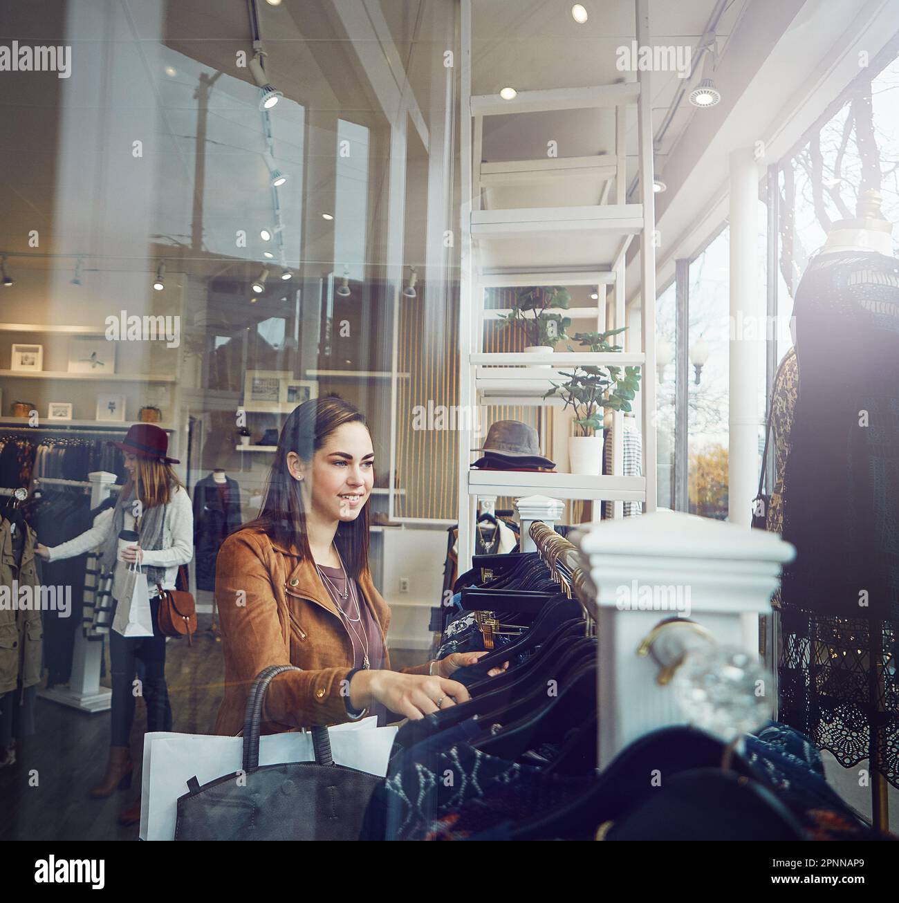 I hope the weather be good to wear this. a young woman shopping at a ...