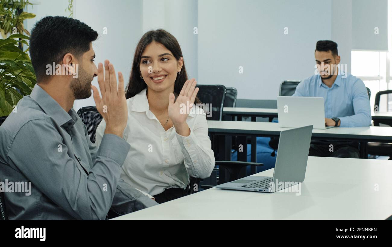 Indian and Caucasian business partners discussing new project at ...