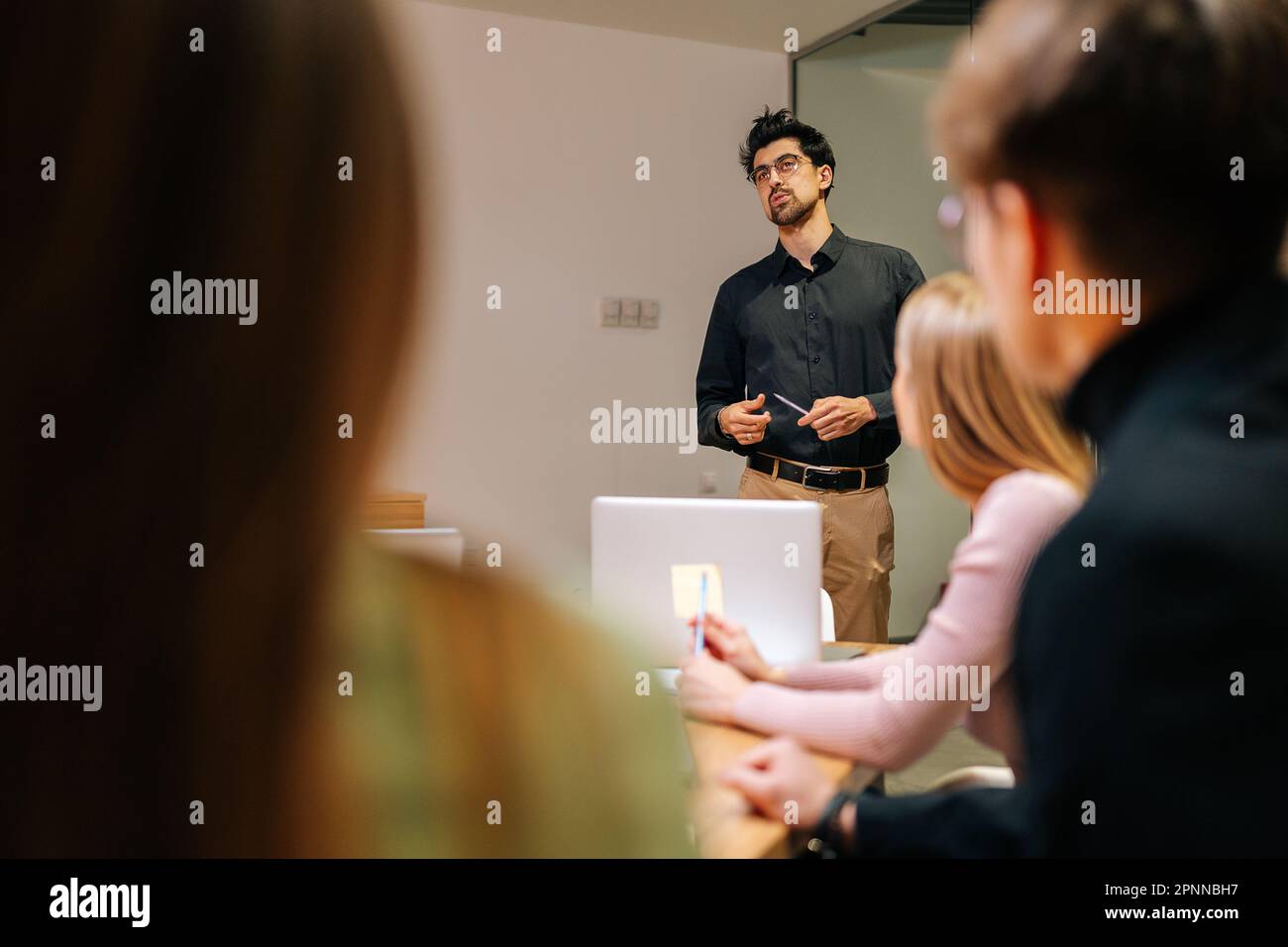 View from shoulder to male business team leader presenting project plan ...