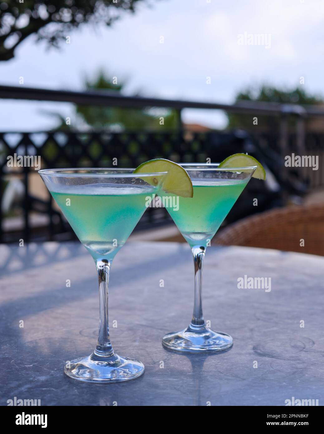 The two cocktails on a table on an outdoor patio Stock Photo - Alamy