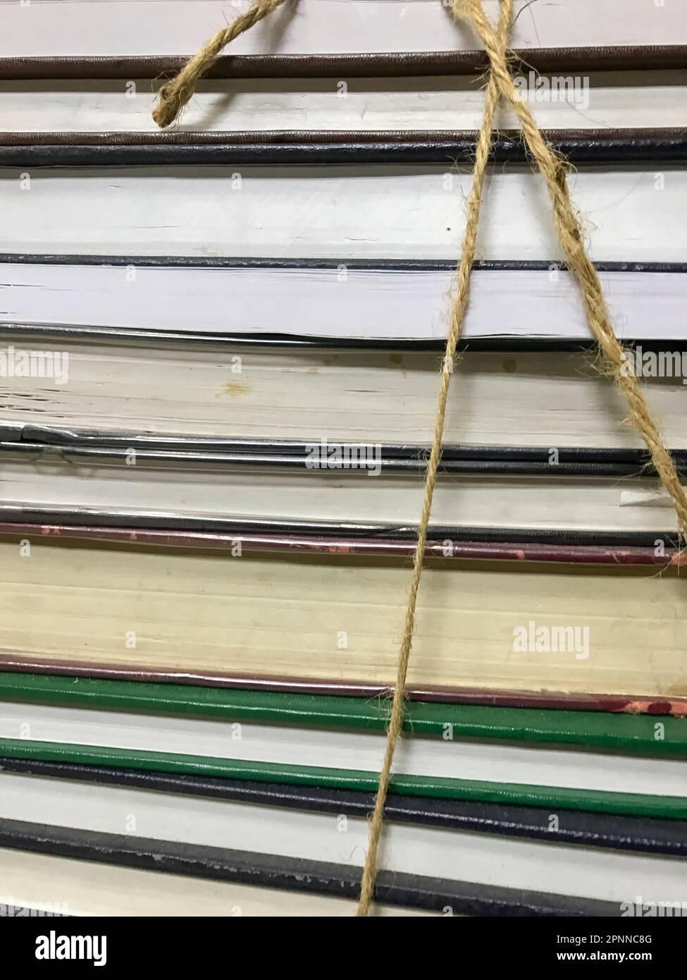 Pile of old books with rope background Stock Photo - Alamy