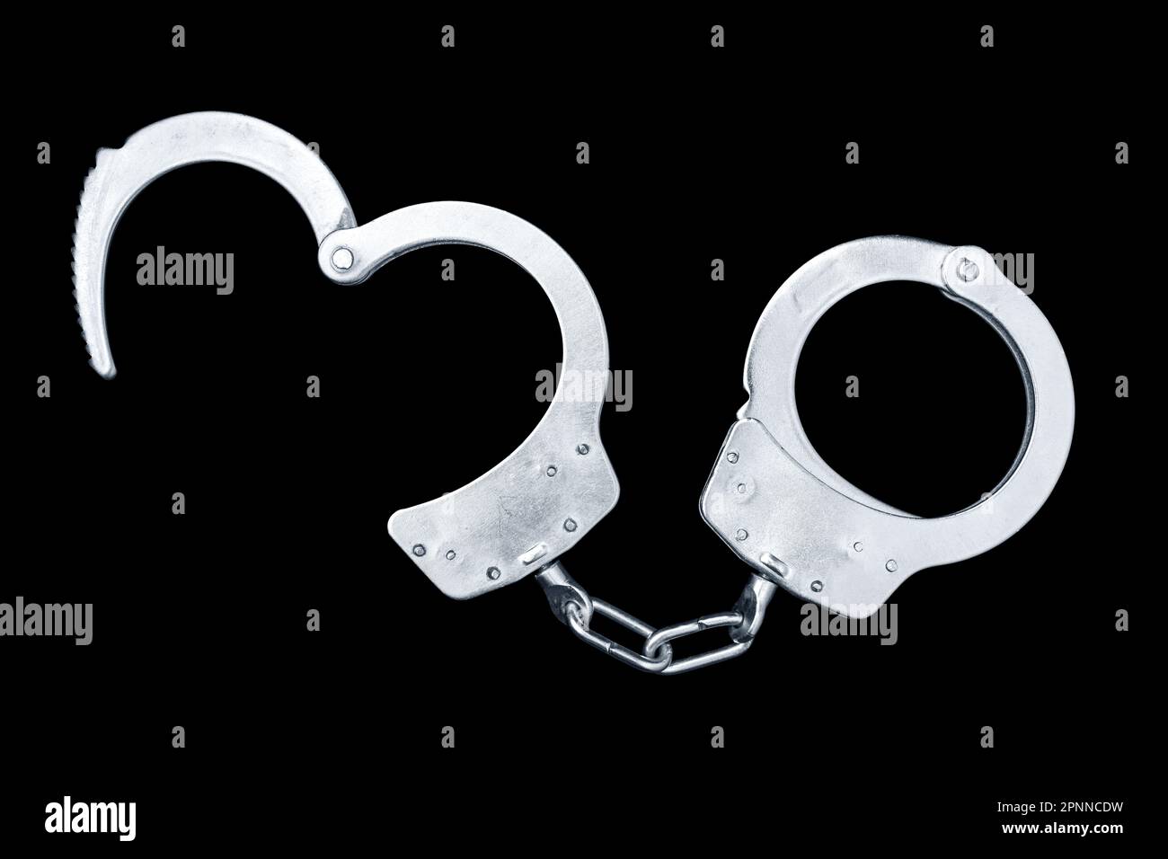 Handcuffs on black background Stock Photo - Alamy