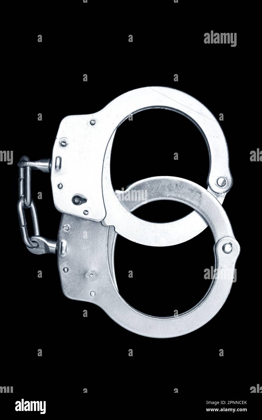 Handcuffs on black background Stock Photo - Alamy