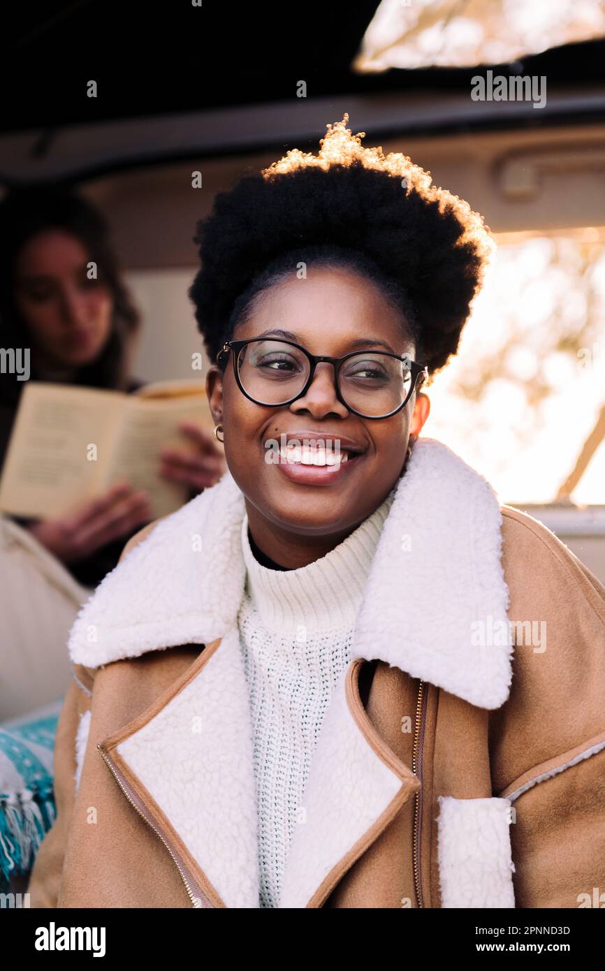 young black woman smiling at sunset in camper van Stock Photo - Alamy
