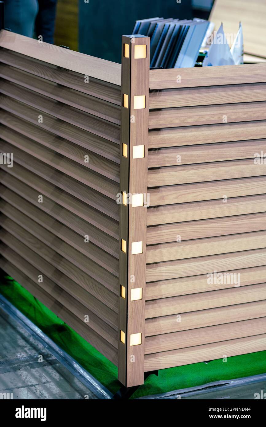 Modern decorative wooden fence with lighting Stock Photo - Alamy