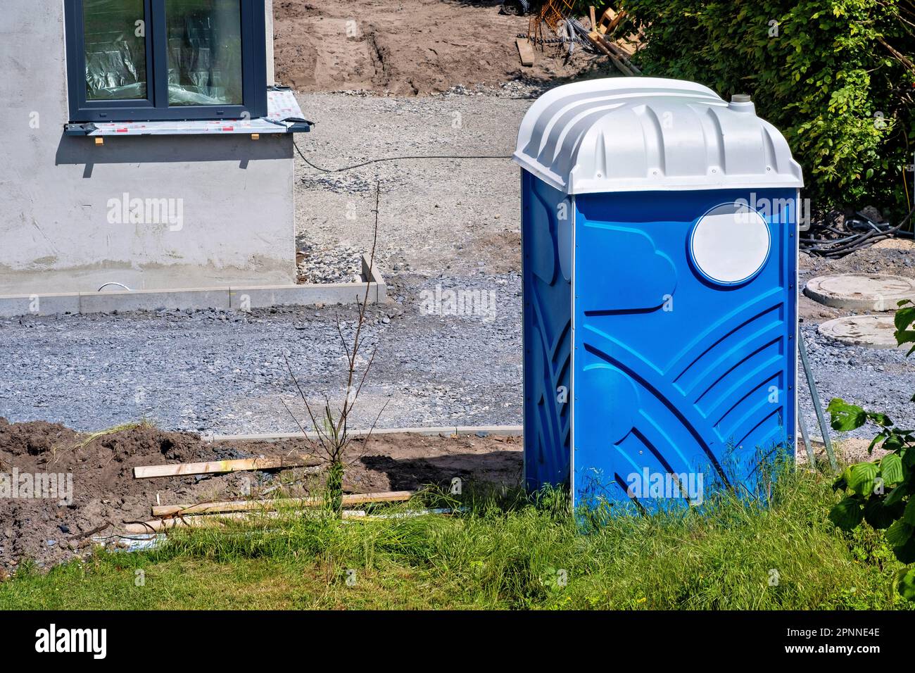 Blue bio-toilet near the private house under construction Stock Photo ...