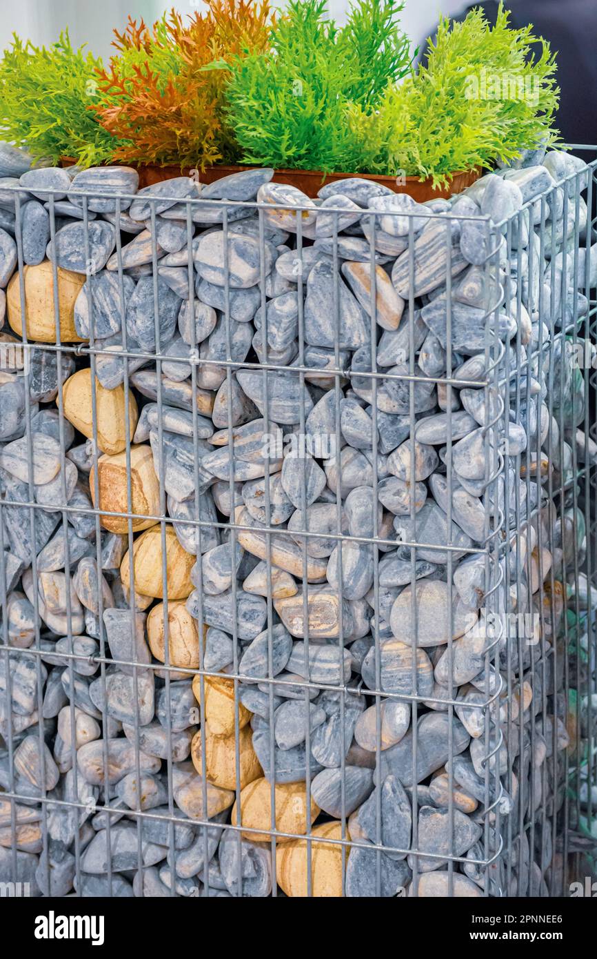 Fencing metal mesh filled with stones Stock Photo - Alamy