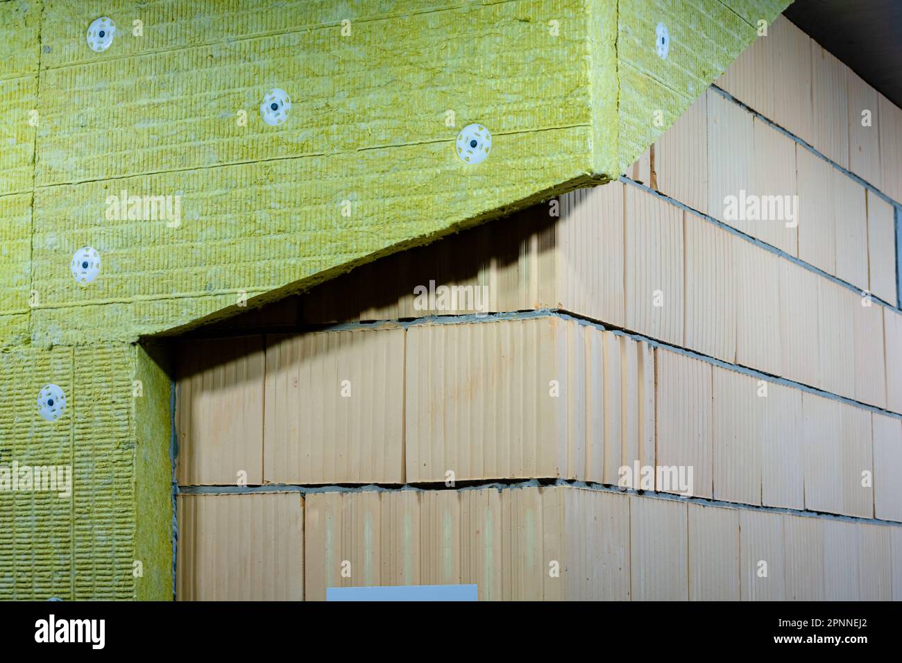 Wall masonry technology with insulation Stock Photo - Alamy