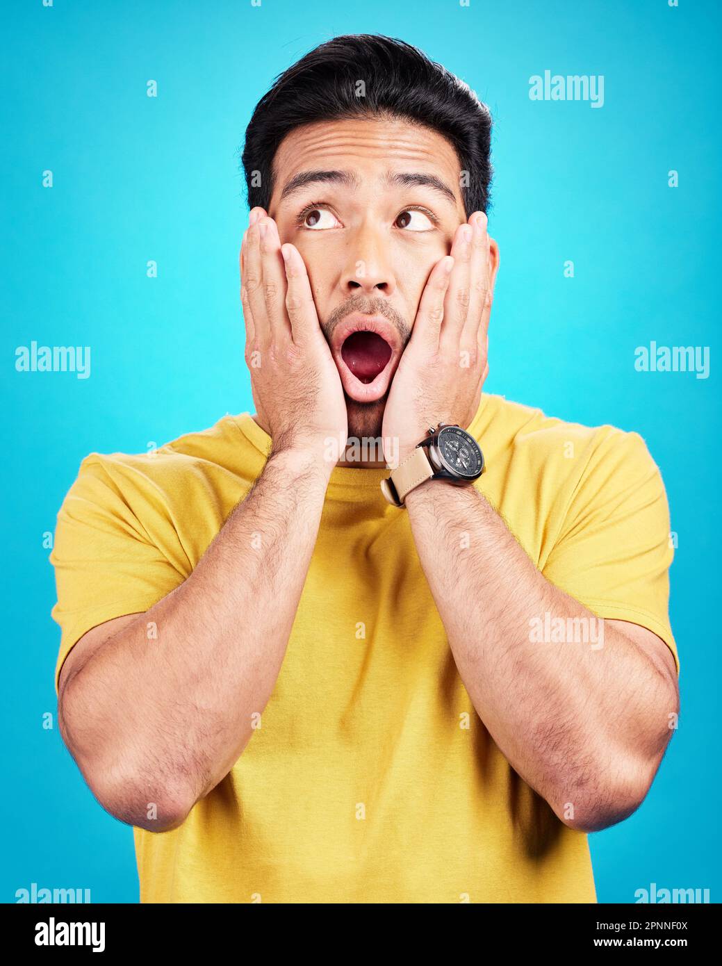 Wow, man and shocked at surprise in studio with announcement, hands on ...