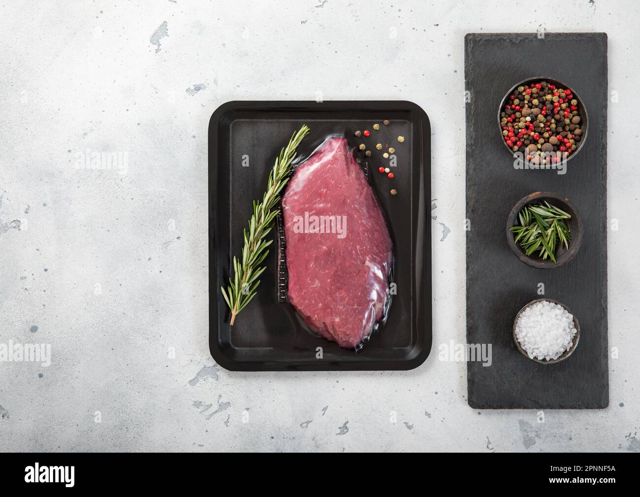 Raw beef fillet steak sealed in vacuum tray with pepper,salt and ...