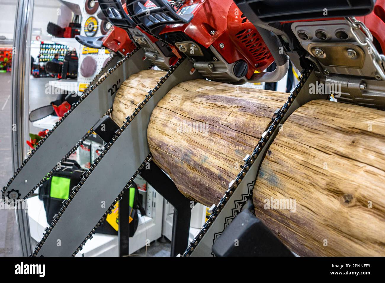 Chainsaw sticking into a tree trunk Stock Photo - Alamy