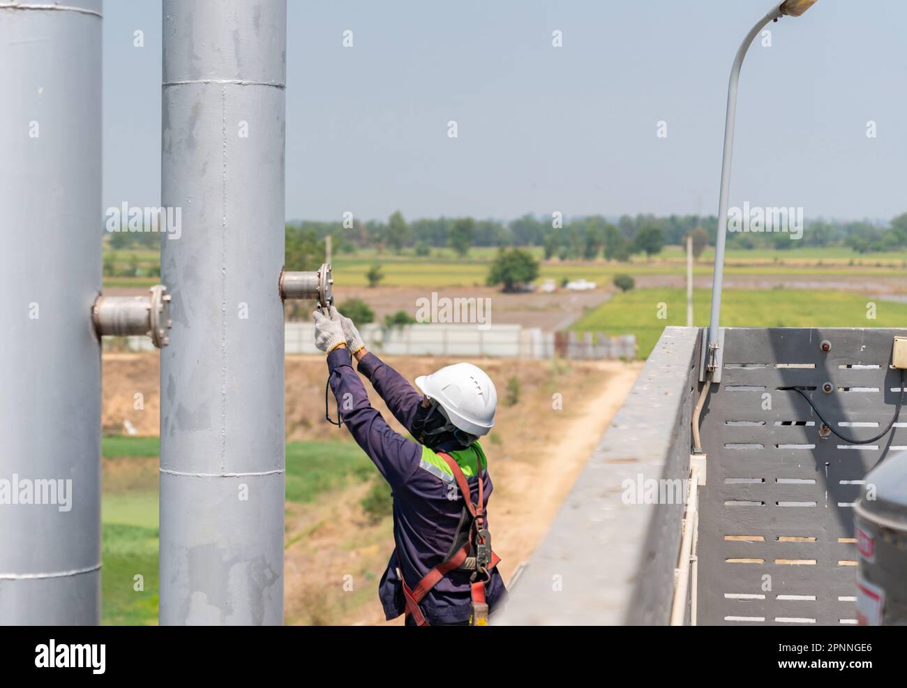 Environment officer remove nut on cover hole stack for sampling air ...