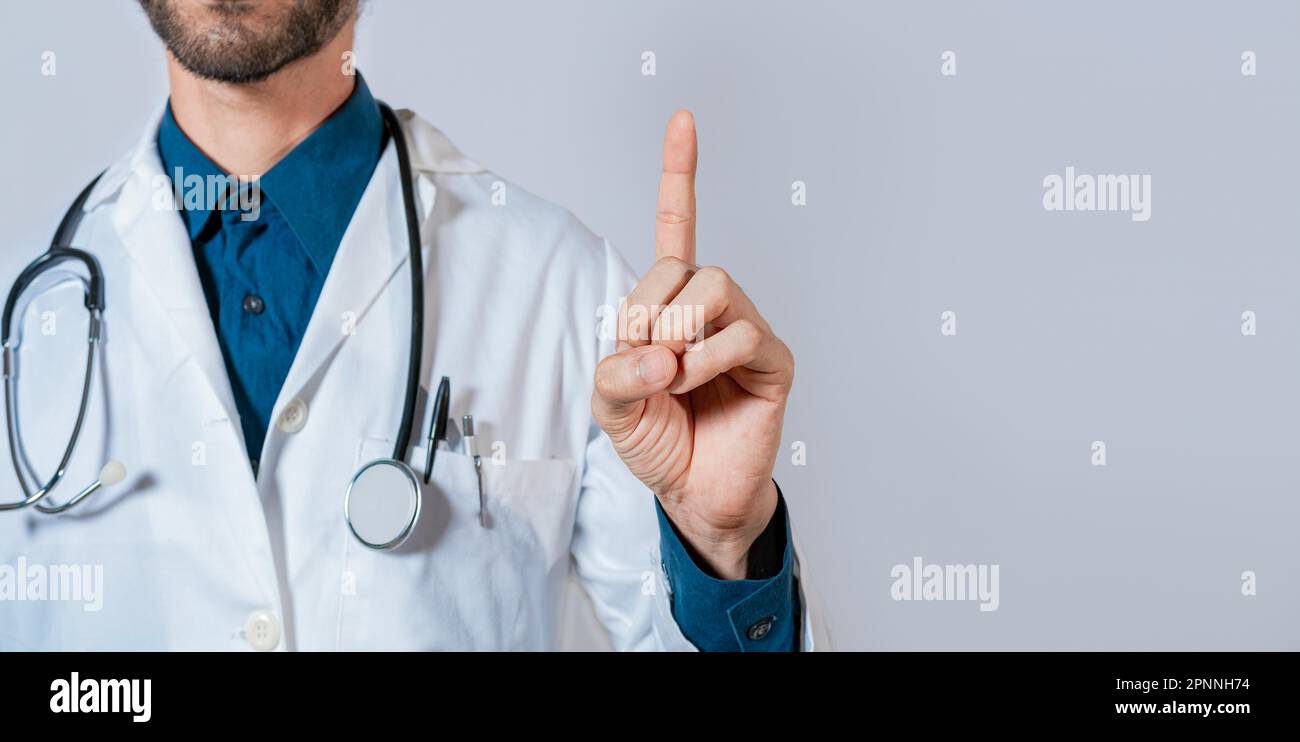 Doctor finger pointing up with text space. Unrecognizable doctor ...