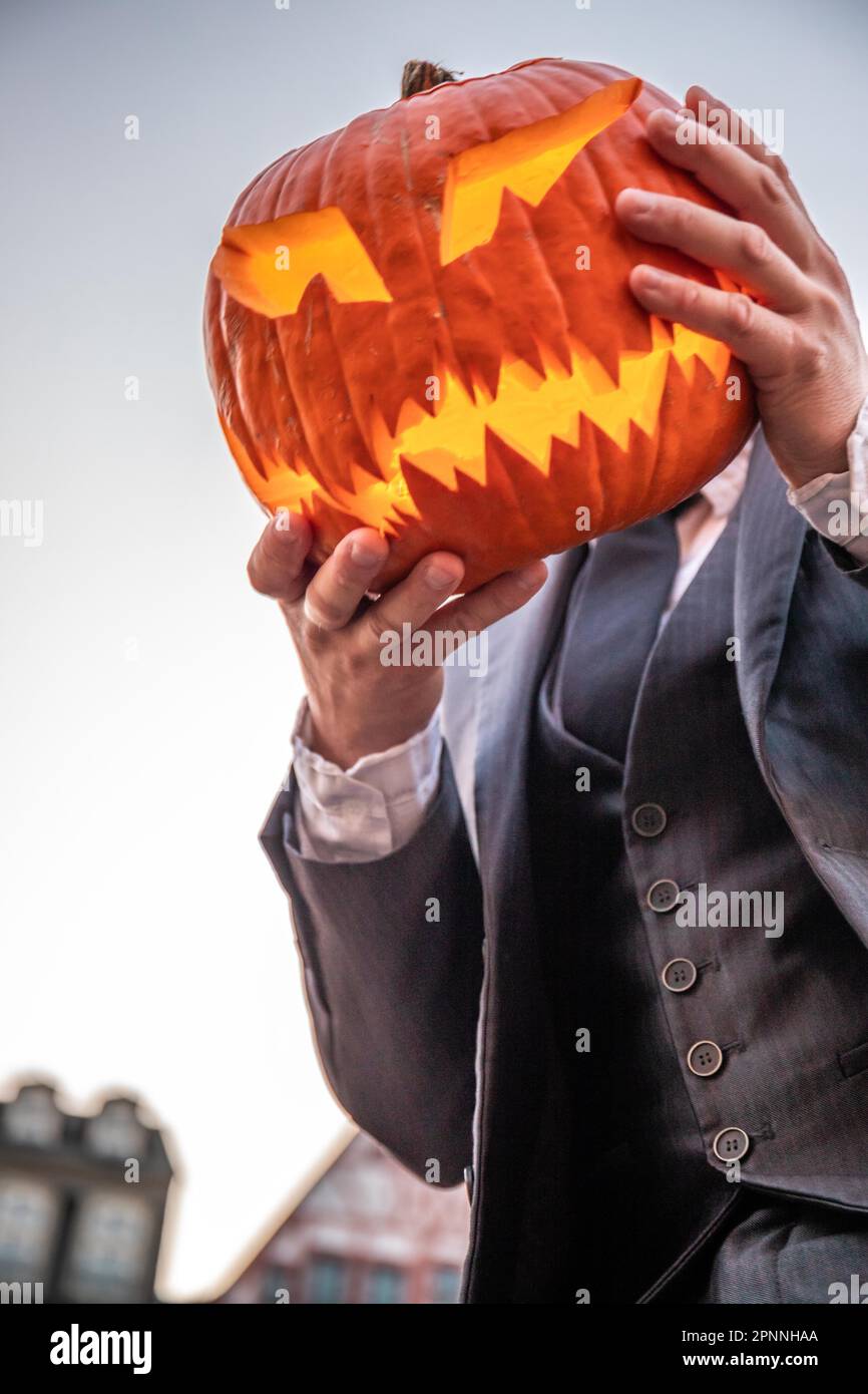 Purge mask, man in a suit with LED mask. At night, city lights ...