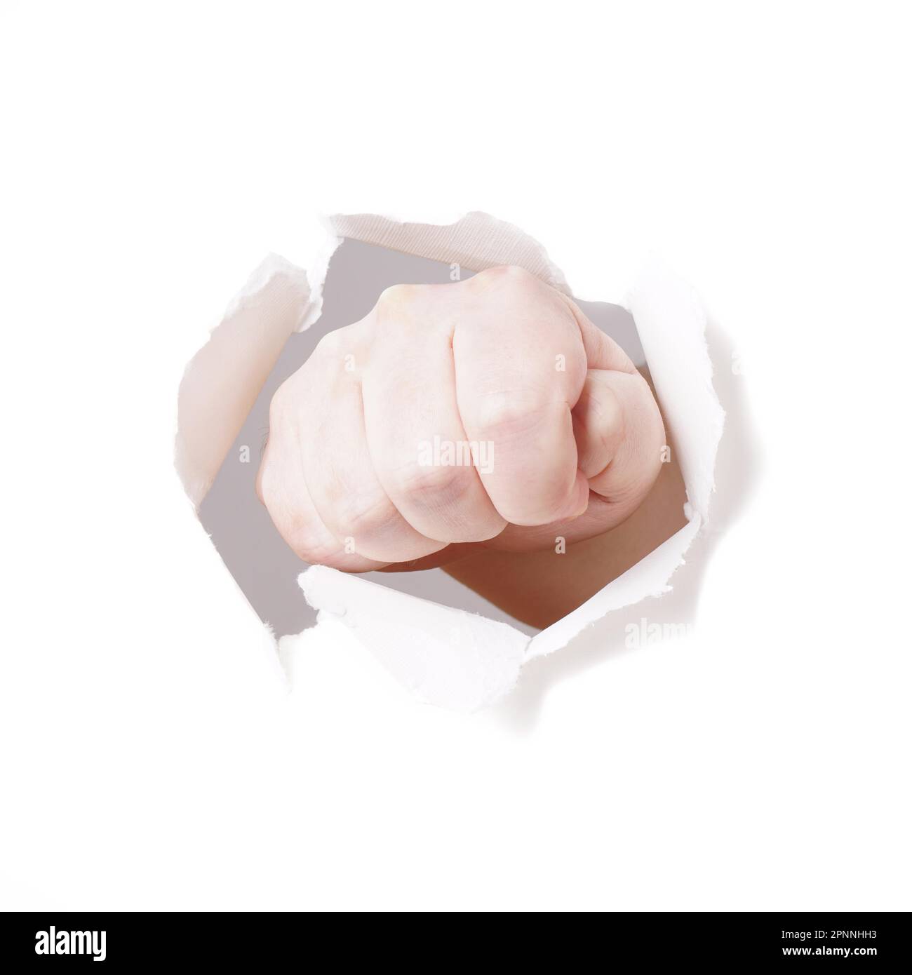 male fist punching hole through paper wall Stock Photo - Alamy