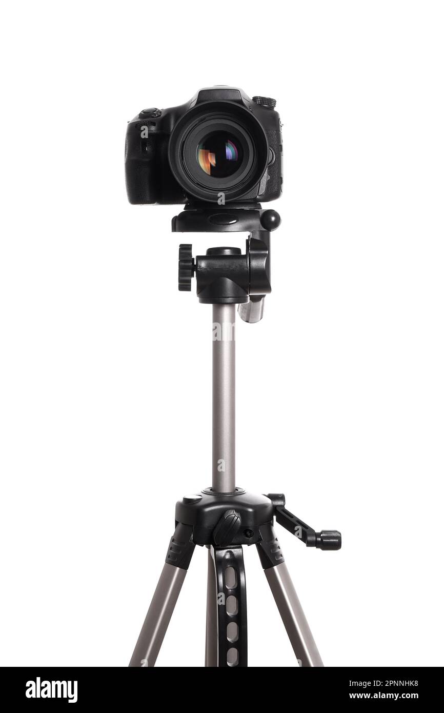 DSLR digital single lens reflex camera on a tripod isolated on white ...