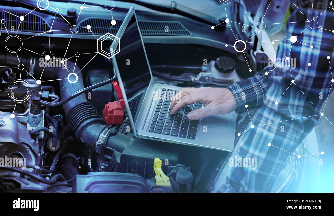 Car mechanic using laptop for checking car engine; light effect Stock ...
