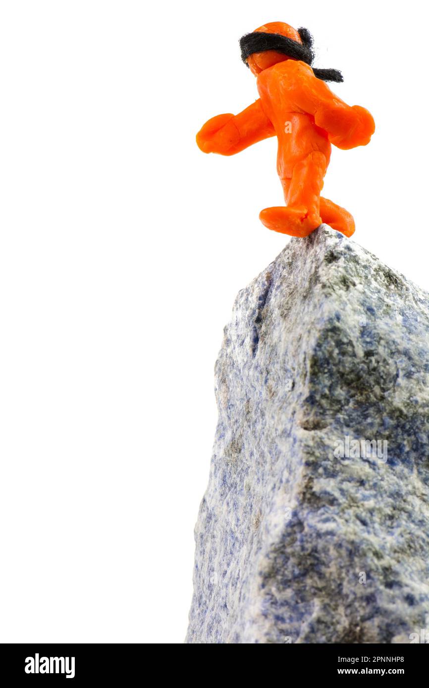 Self-made human plasticine figure walking to the edge of the abyss ...