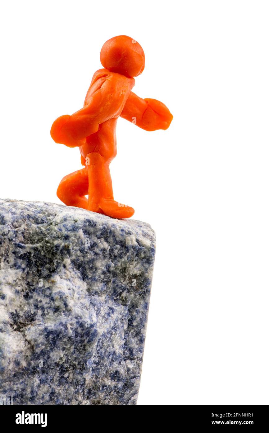 Self-made human plasticine figure walking to the edge of the abyss ...