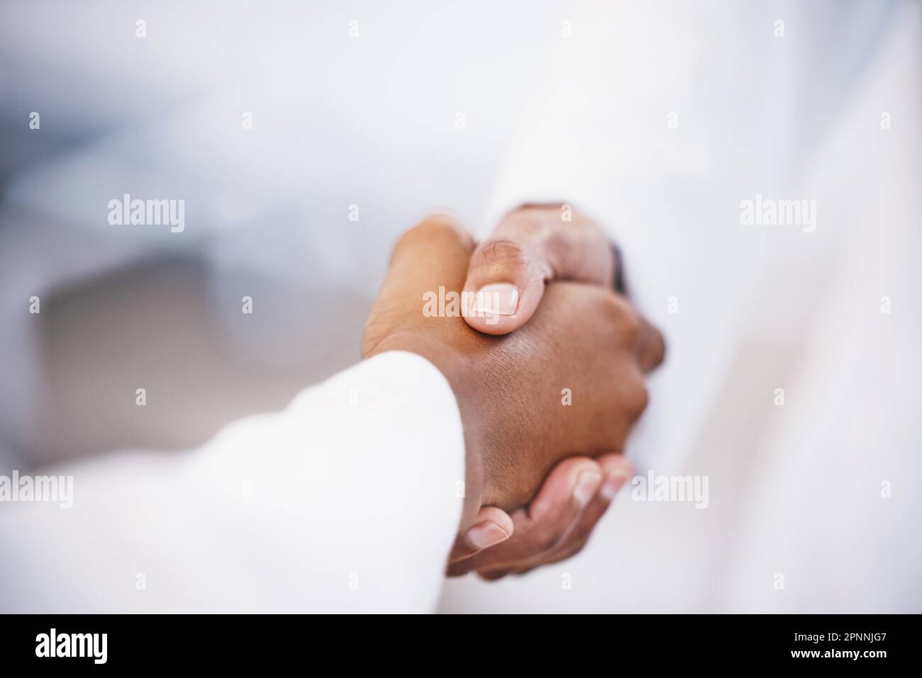 Doctor, handshake and meeting in thank you for agreement, deal or ...