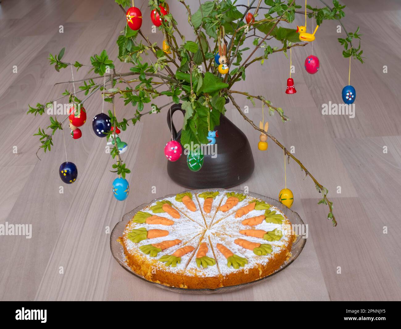 Homemade carrot cake in front of a shrub with Easter decorations Stock ...