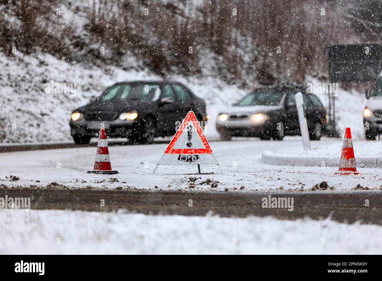 Winter traffic conditions, snow lies on the road, traffic sign ...