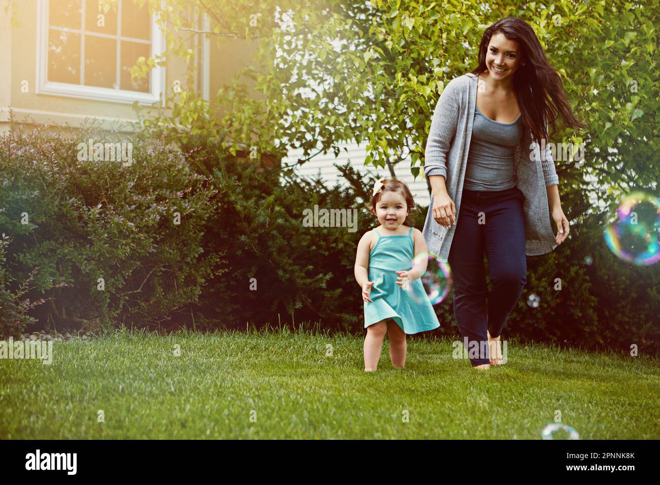 Come on Mom, weve got so many bubbles to catch. a mother and her ...