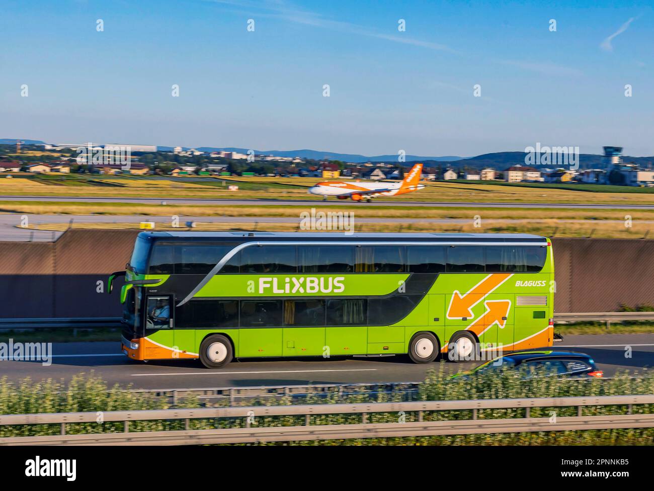 Flixbus on the road on the A8 motorway at the airport, EasyJet airline ...
