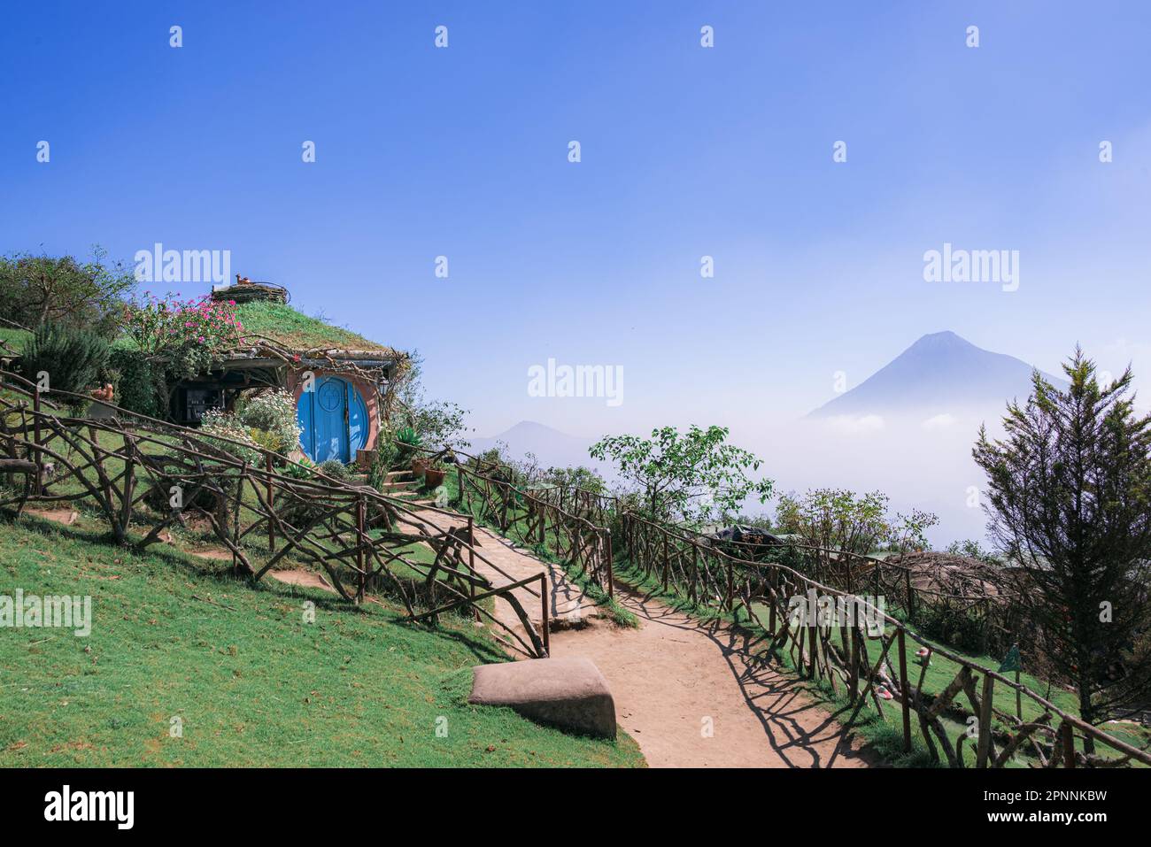 A pathway leading to the Hobbitenango Lodge with a scenic view in the ...