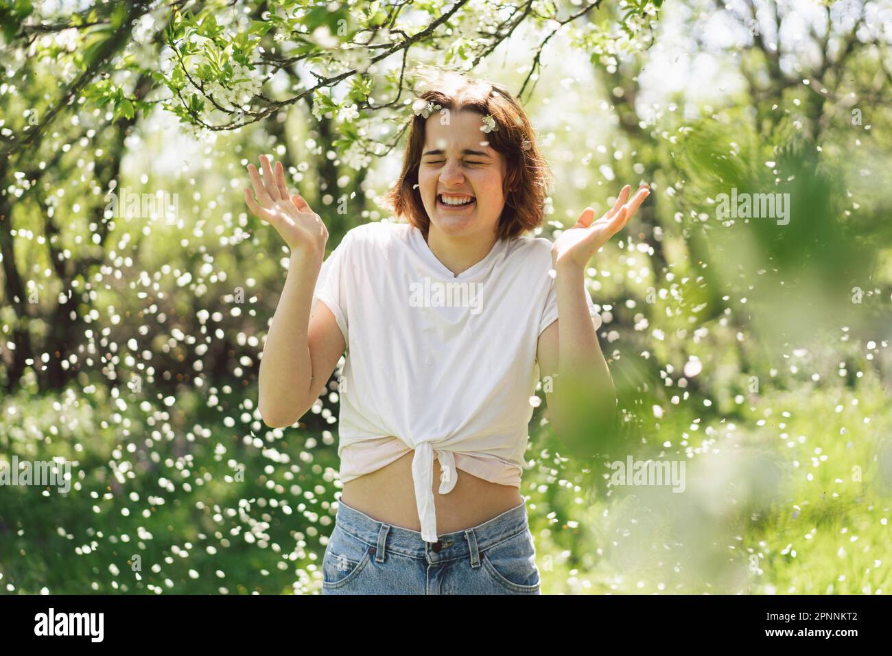 Beautiful teenage girl with spring flowers enjoying nature and laughing ...