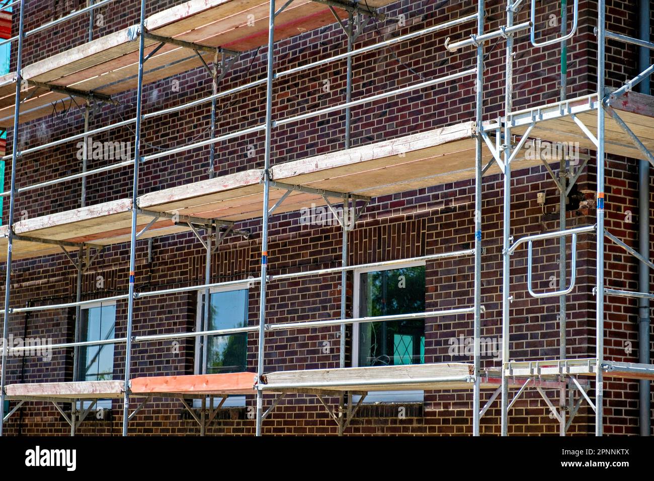 Scaffolding near a high-rise brick house under construction in Germany ...