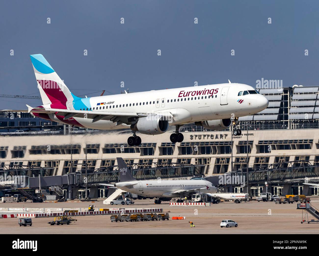 Airbus A320-200 of the airline Eurowings during landing, terminal at ...