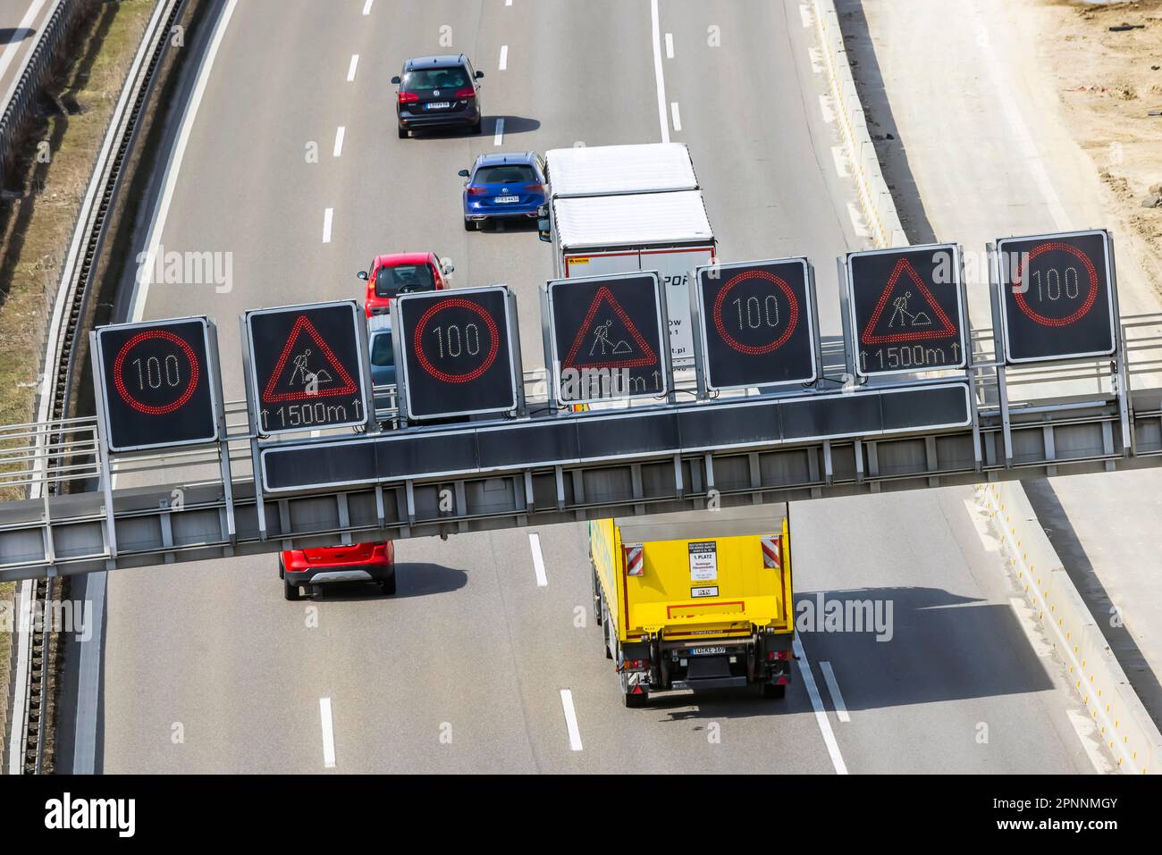 Sign bridge over a motorway, traffic sign speed limit and danger due to ...