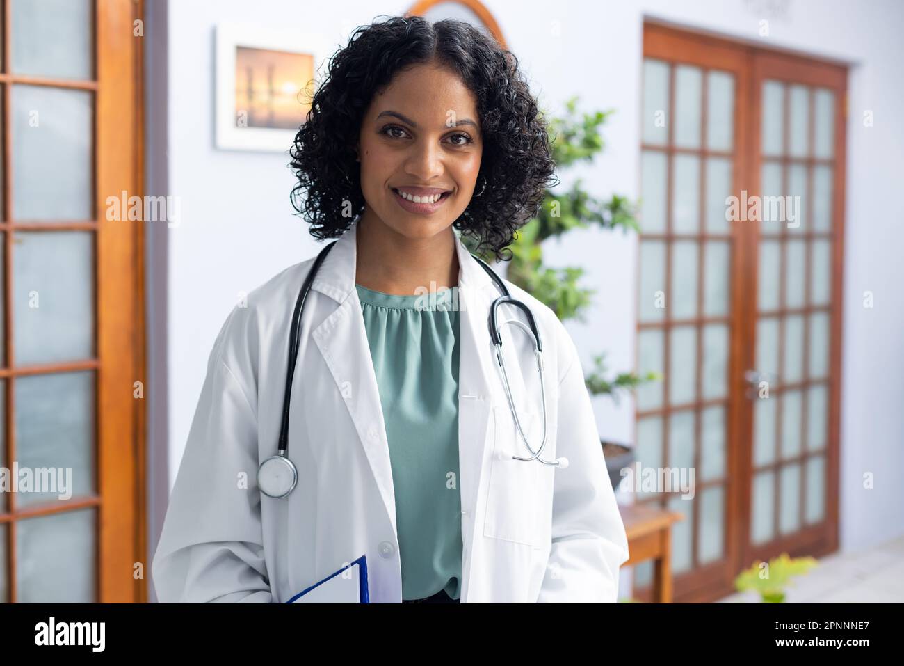 Portrait of happy biracial female doctor wearing stethoscope and ...