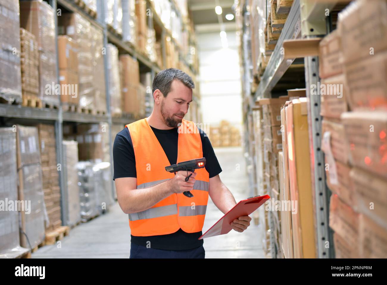 friendly warehouse worker in a warehouse with the barcode scanner Stock ...