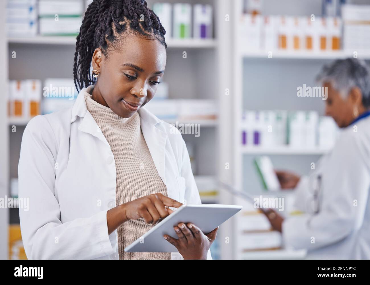 Black woman, doctor and tablet for inventory inspection at pharmacy for ...