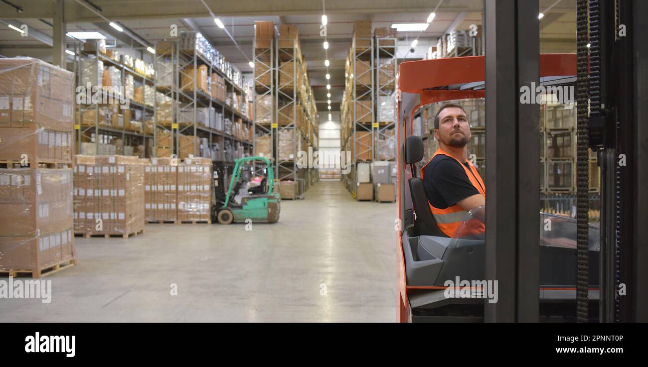warehouse worker in a forwarding agency - interior with forklift ...