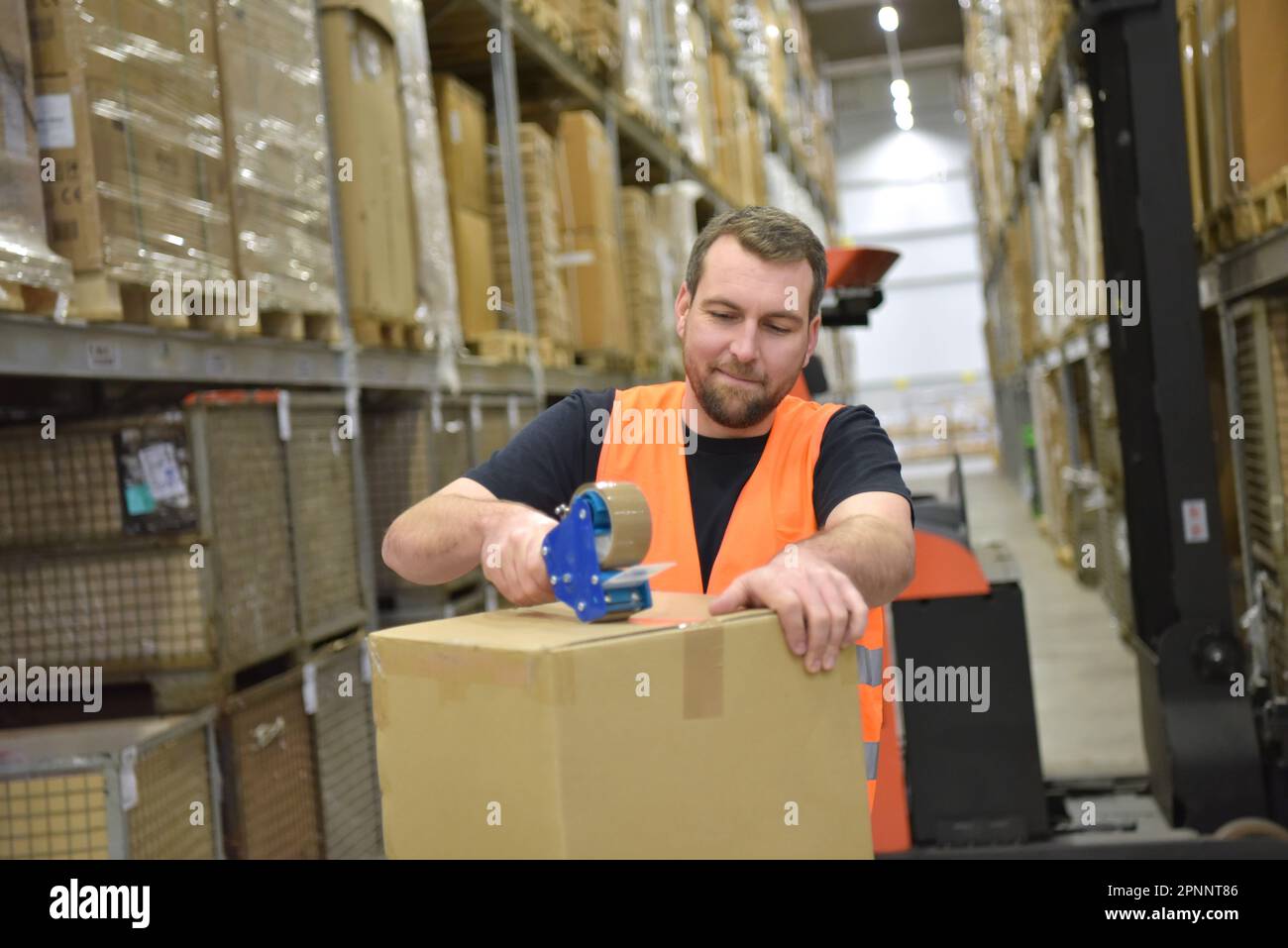 workers in a goods warehouse in the retail trade packaged a package ...