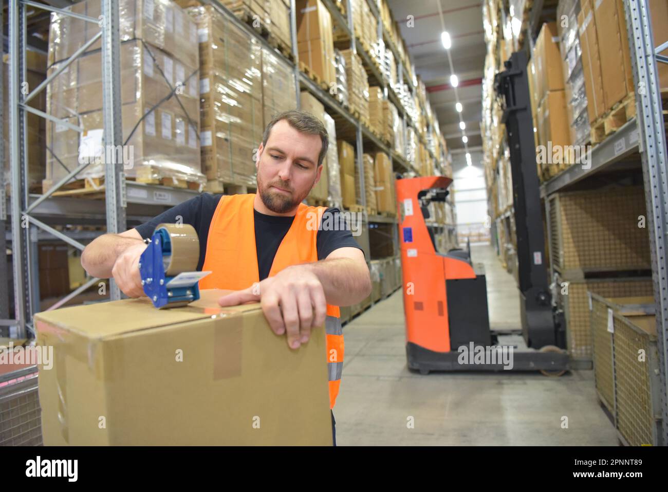 workers in a goods warehouse in the retail trade packaged a package ...