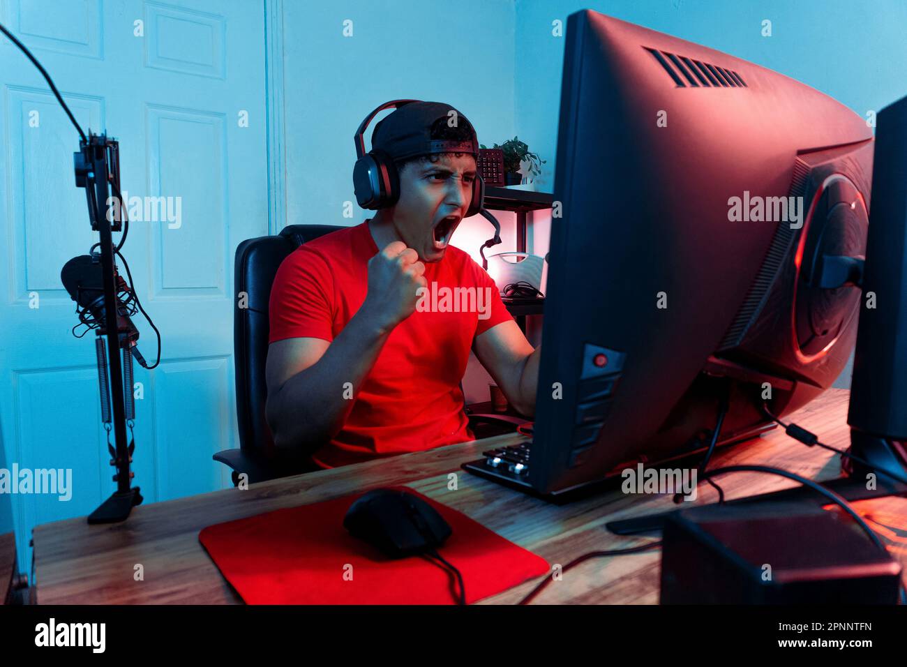 Euphoric young Latin American streamer celebrating a victory. Online ...