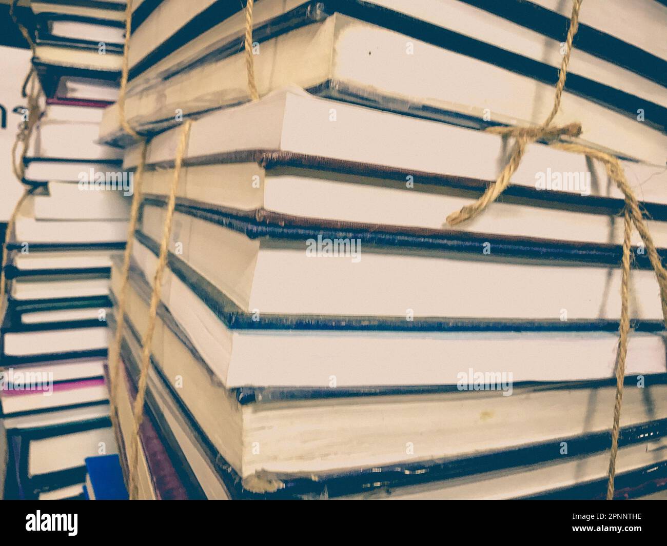 Pile of old books with rope background Stock Photo - Alamy