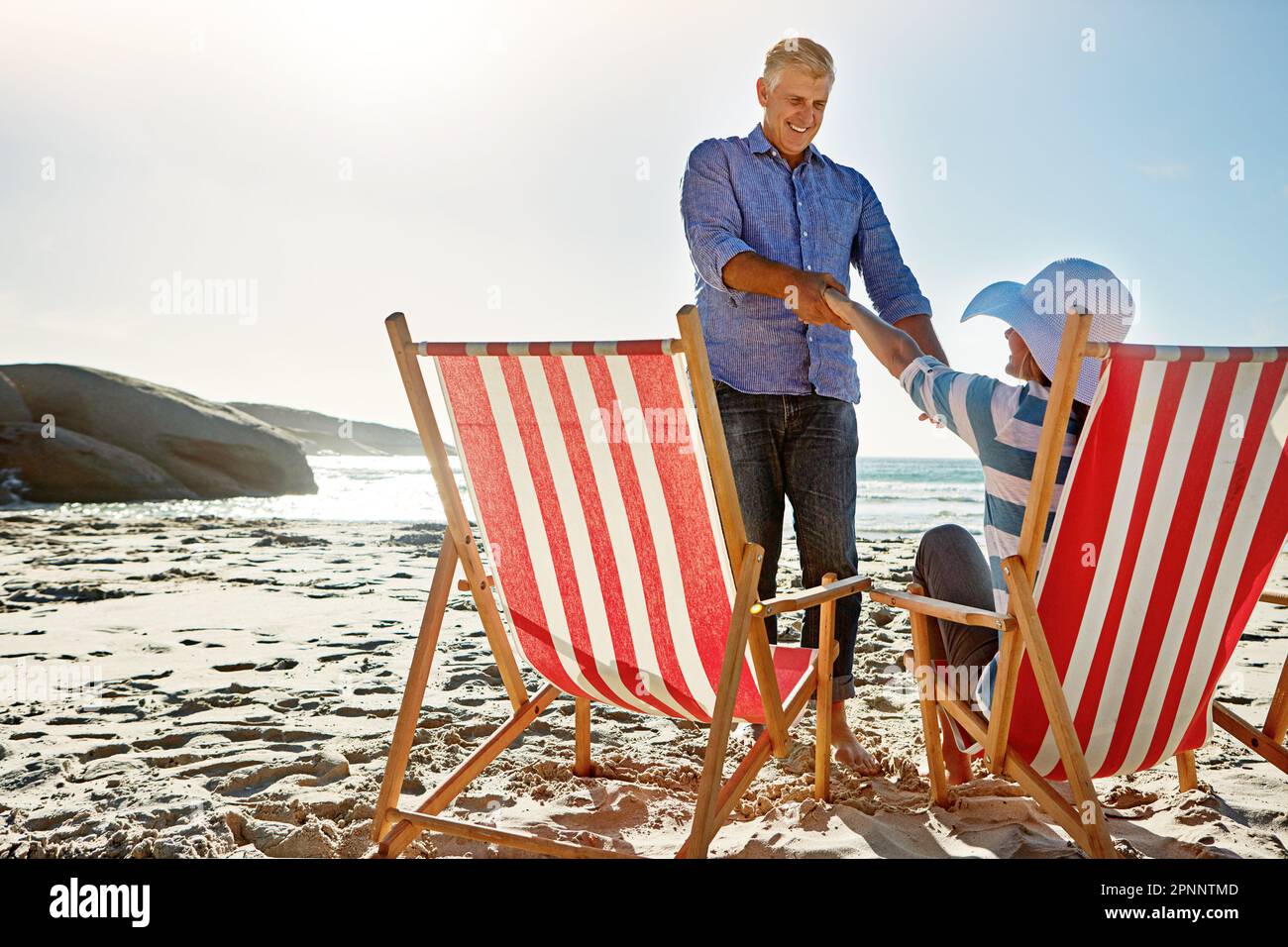 Lets go put our feet in the water. a mature couple spending the day at ...