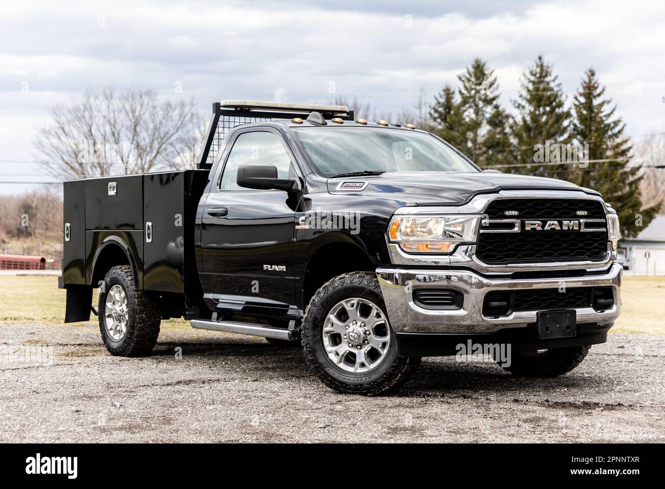 A black Ram truck parked on a concrete surface in a natural setting ...