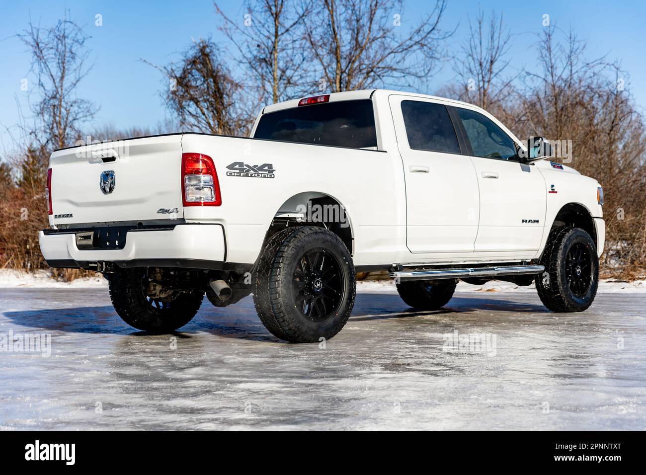 A white Dodge Ram 2500 truck parked on a concrete surface in a natural ...